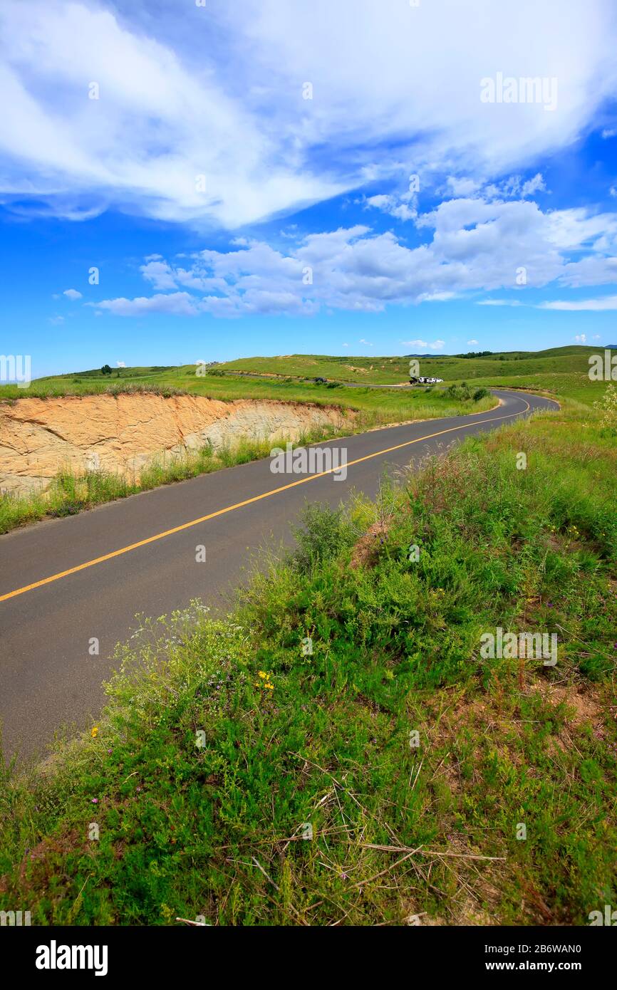 The asphalt road is on the prairie Stock Photo - Alamy