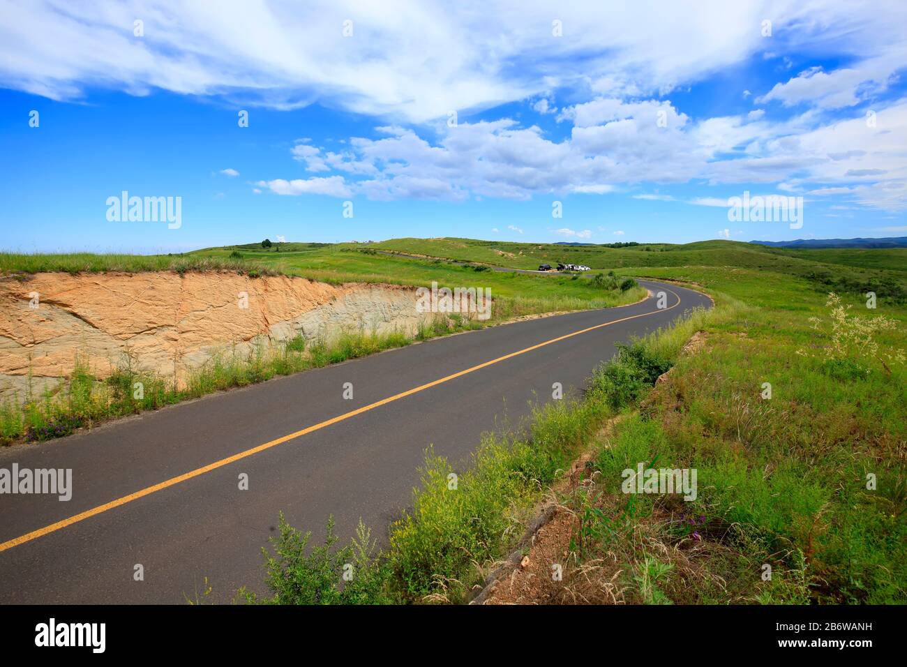 The asphalt road is on the prairie Stock Photo - Alamy
