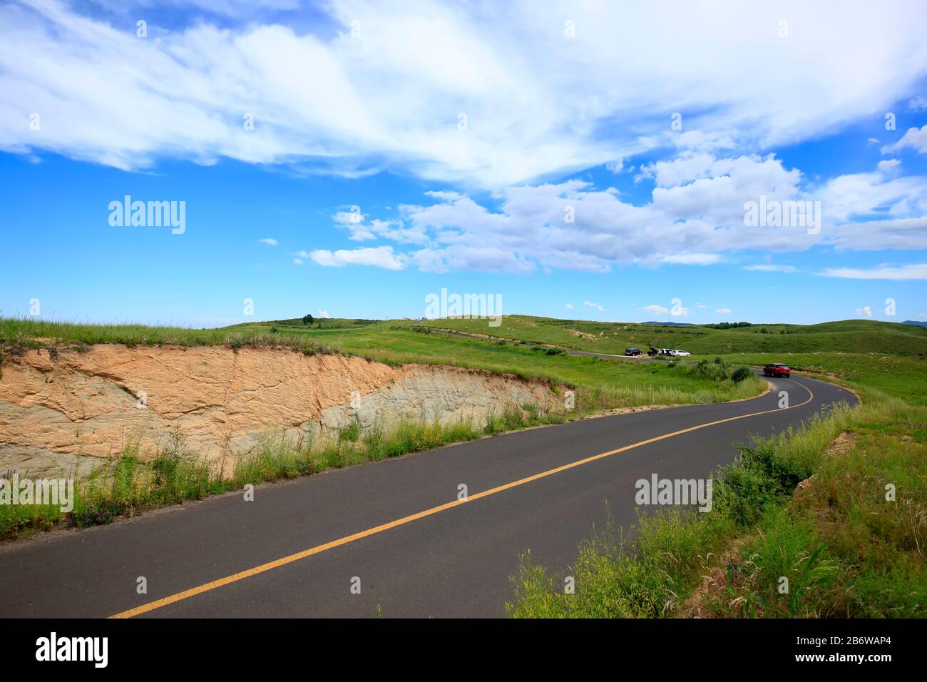 The asphalt road is on the prairie Stock Photo - Alamy