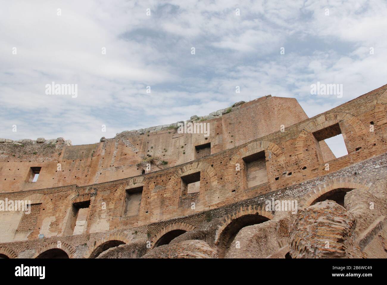 Interior of the Colosseum or Coliseum with the bricks wall and arches ...