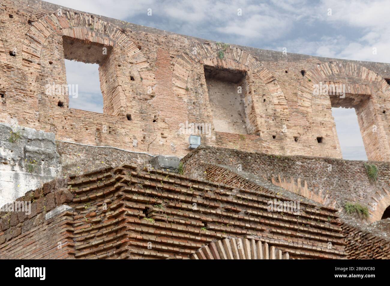 Interior of the Colosseum or Coliseum with the bricks wall and arches ...