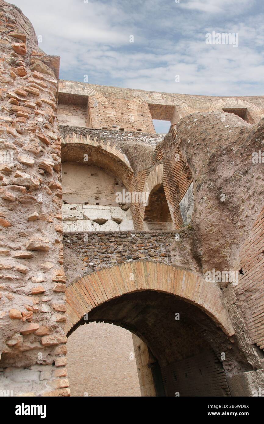 Interior of the Colosseum or Coliseum with the bricks wall and arches ...