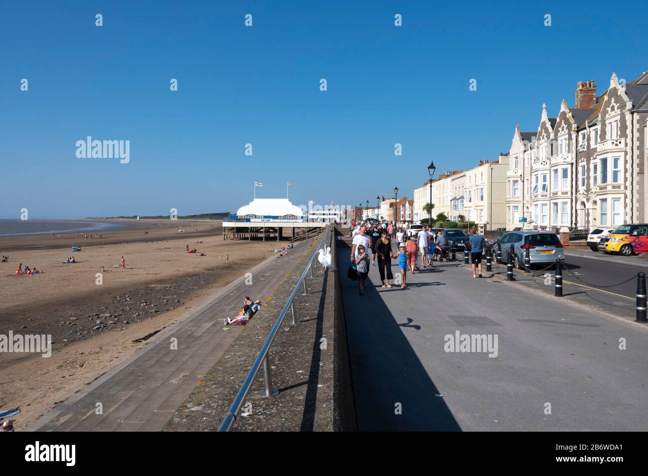 Holiday makers walking along the promenade at Burnham-on-Sea, Somerset ...