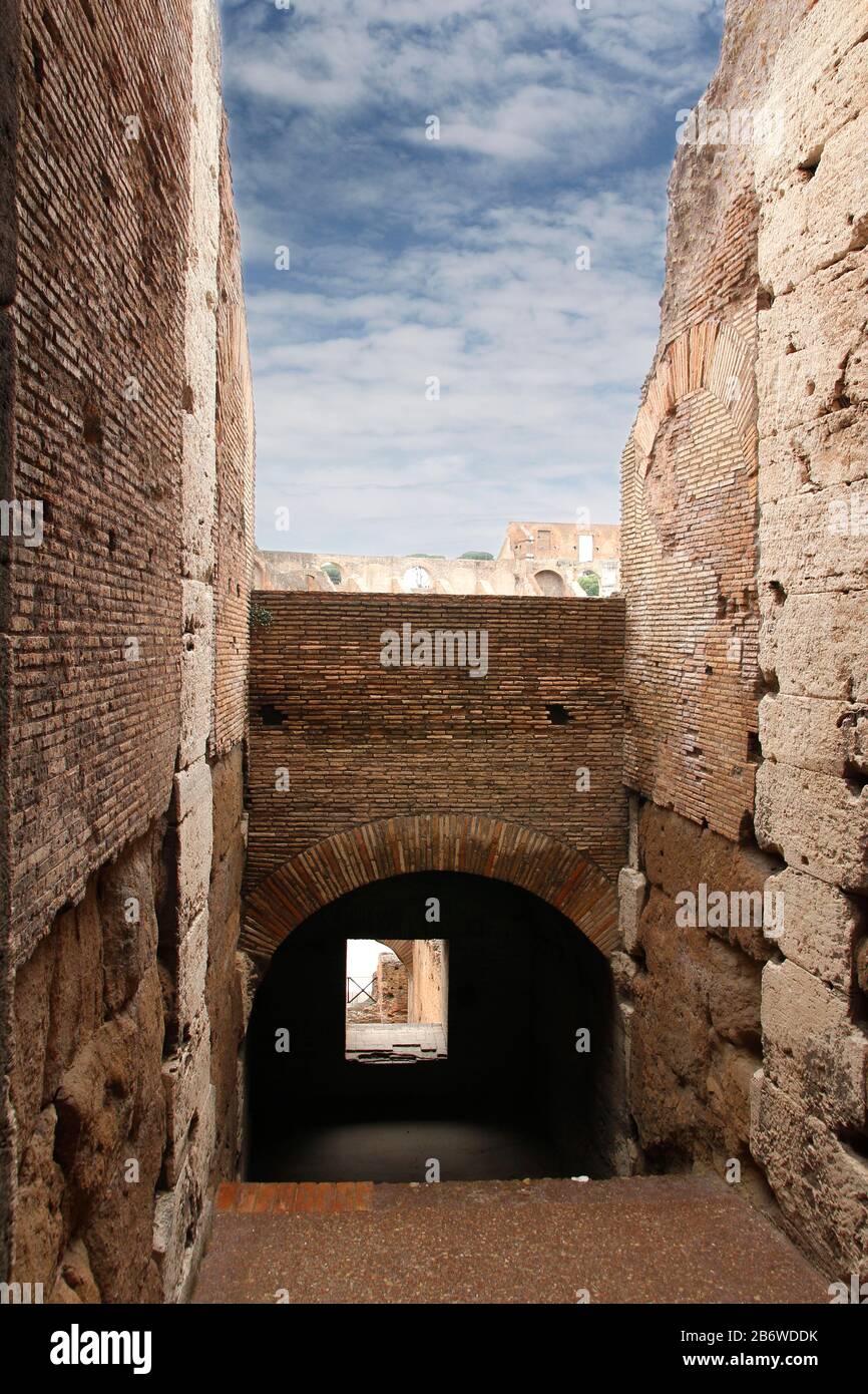 Interior of the Colosseum or Coliseum with the bricks wall and arches ...