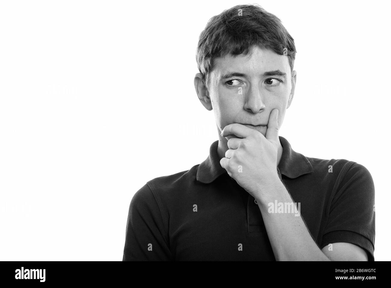 Studio shot of man thinking while looking down Stock Photo - Alamy