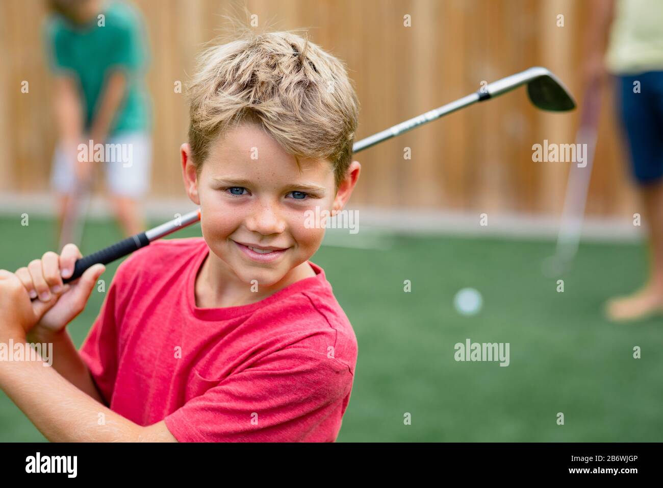 Cute boy playing golf hi-res stock photography and images - Alamy
