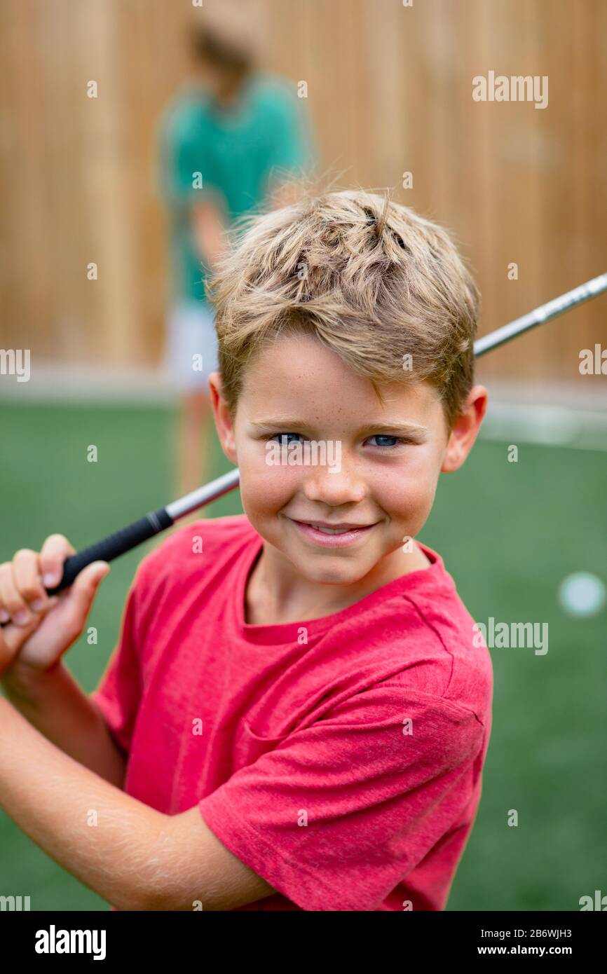 Cute boy playing golf hi-res stock photography and images - Alamy