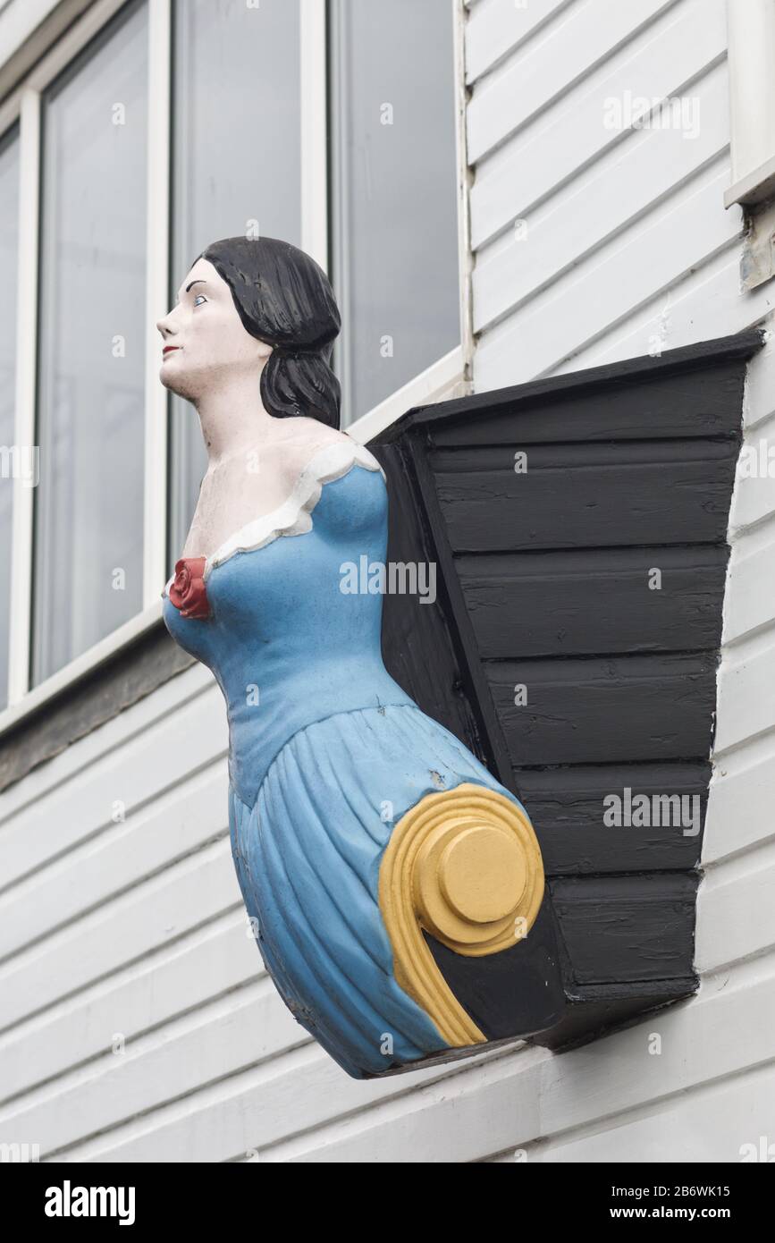 400 year old ships figurehead, mounted on the exterior of a building in ...