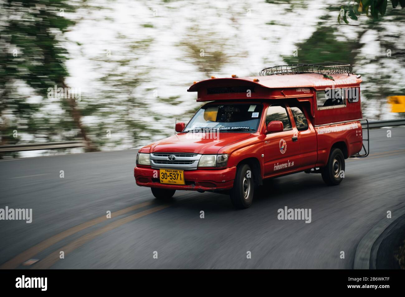 Red traditional thailandese van going fast through the jungle Stock ...