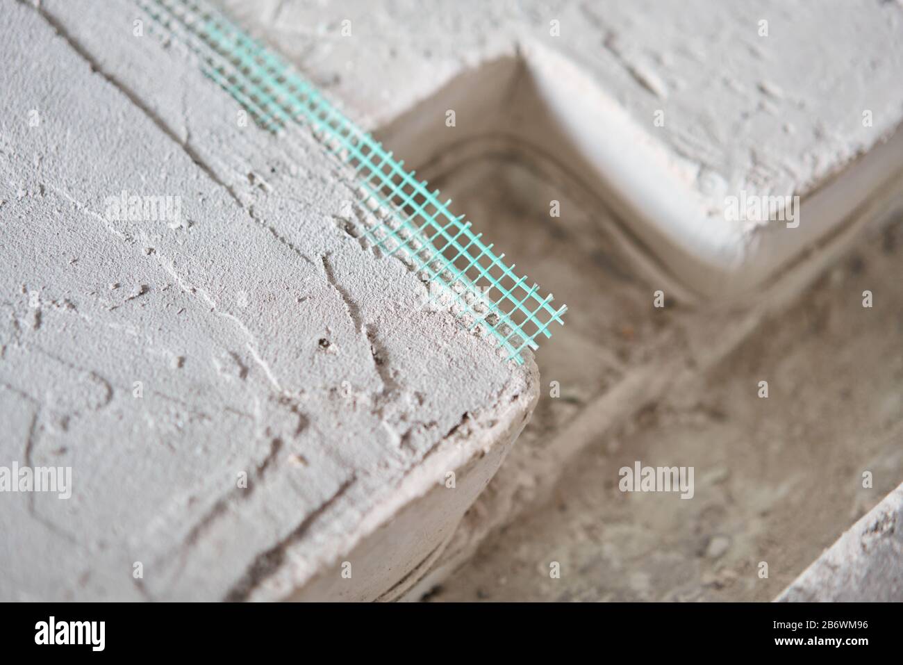 The finished floor screed is reinforced with green mesh. Repair of ...