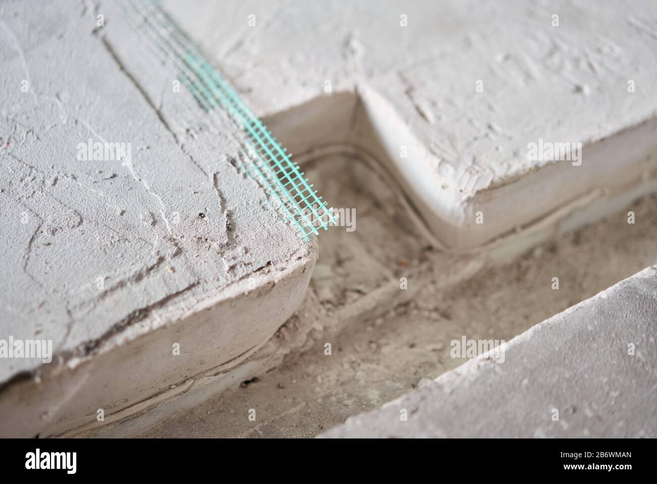 The finished floor screed is reinforced with green mesh. Repair of ...