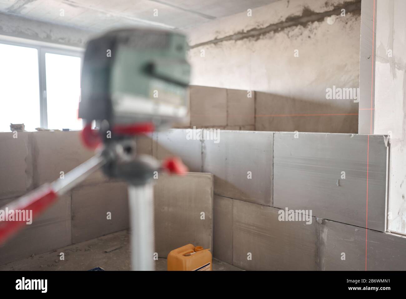 The construction worker Measures horizon level with a laser level ...