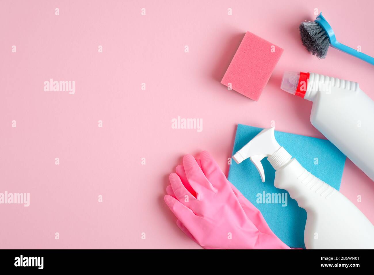 Cleaning supplies on pink background with copy space. House cleaning ...