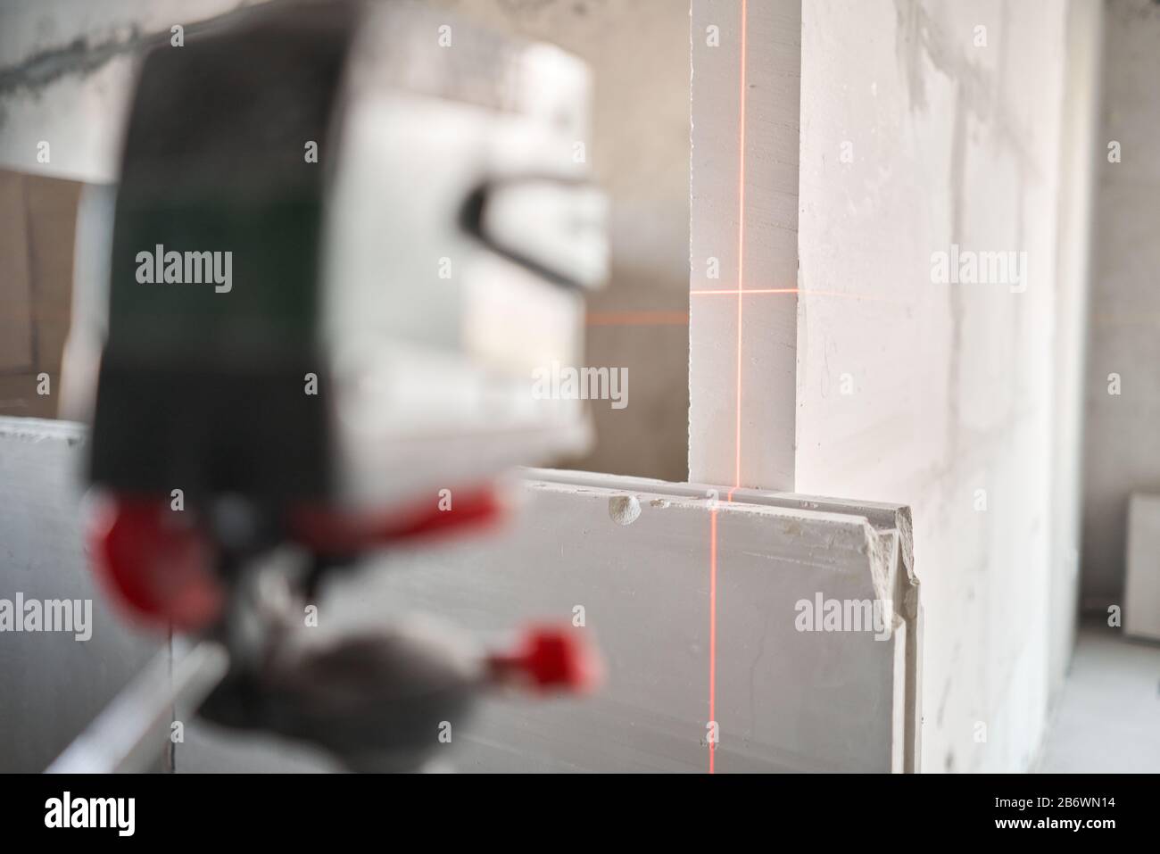 The construction worker Measures horizon level with a laser level ...