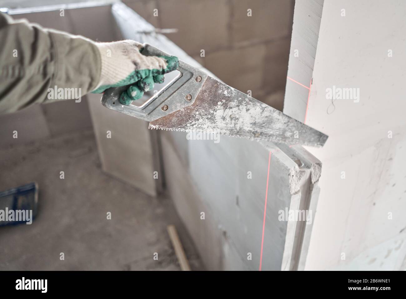 Saw in hand saws Gypsum plate. Construction of internal walls in the ...