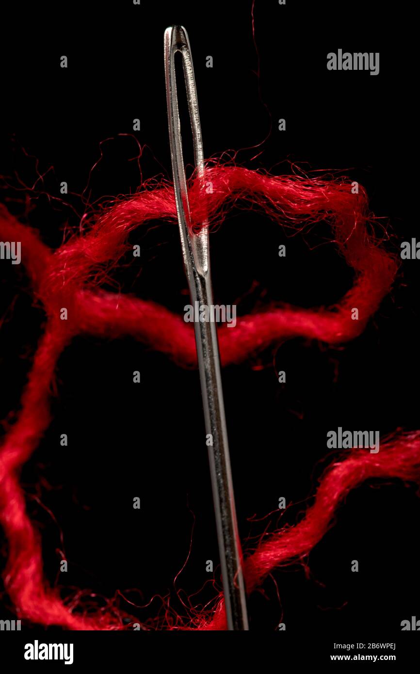 Needle with braided thread macro view on black background Stock Photo ...