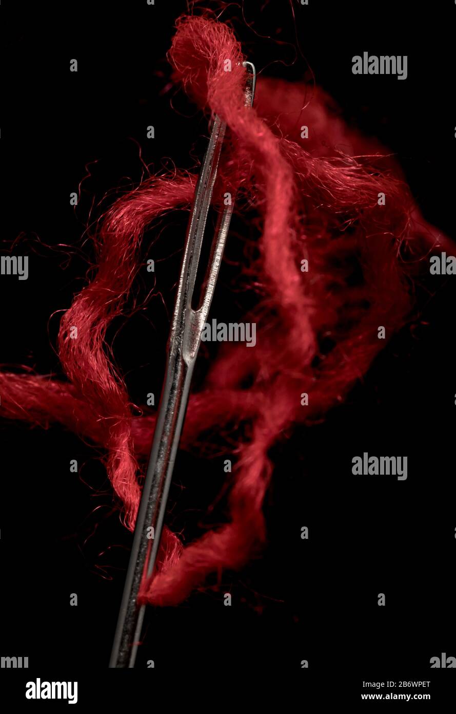 Needle with braided thread macro view on black background Stock Photo ...