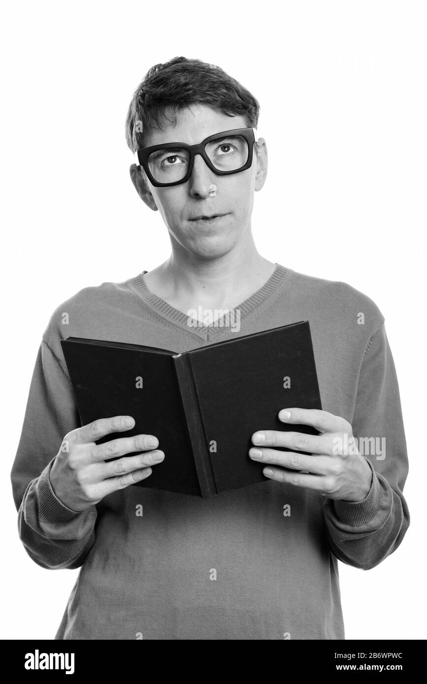 Portrait of nerd man thinking while holding book Stock Photo - Alamy