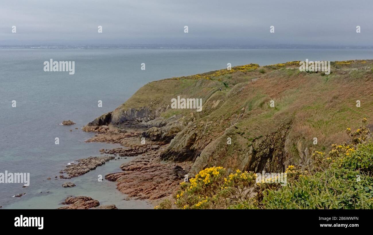 Rocky cliffs and beach along the north sea coast of howth, Dublin ...