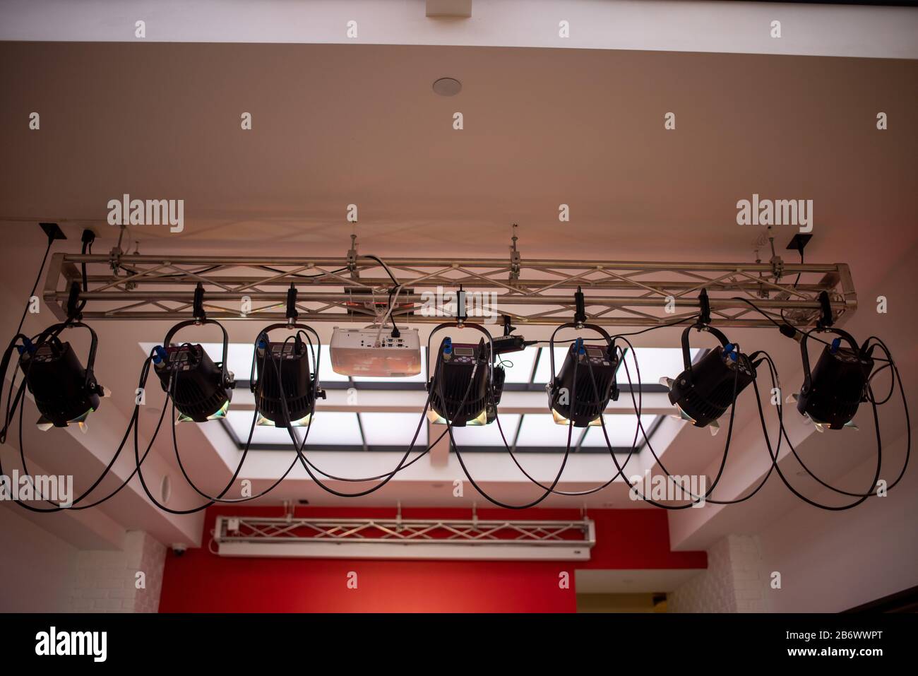Stage light mounted against roof at performance space Stock Photo - Alamy