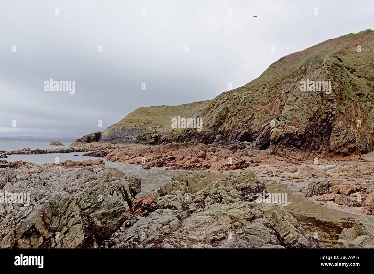 Rocky cliffs and beach along the north sea coast of howth, Dublin ...