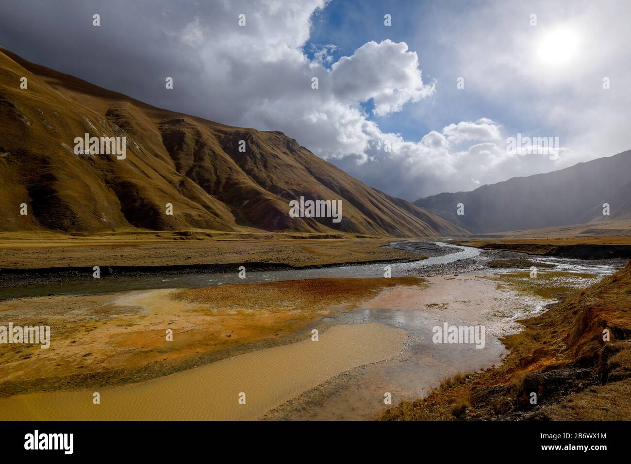 Terek River Valley, Georgia. BLue sky with clouds in background. River ...