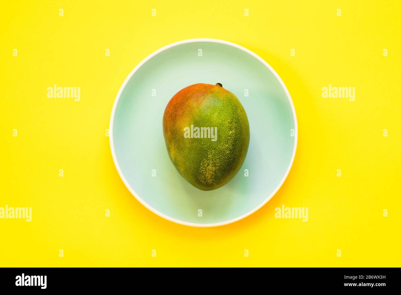 Mango Lying On A Blue Plate. Flat Lay Stock Photo - Alamy