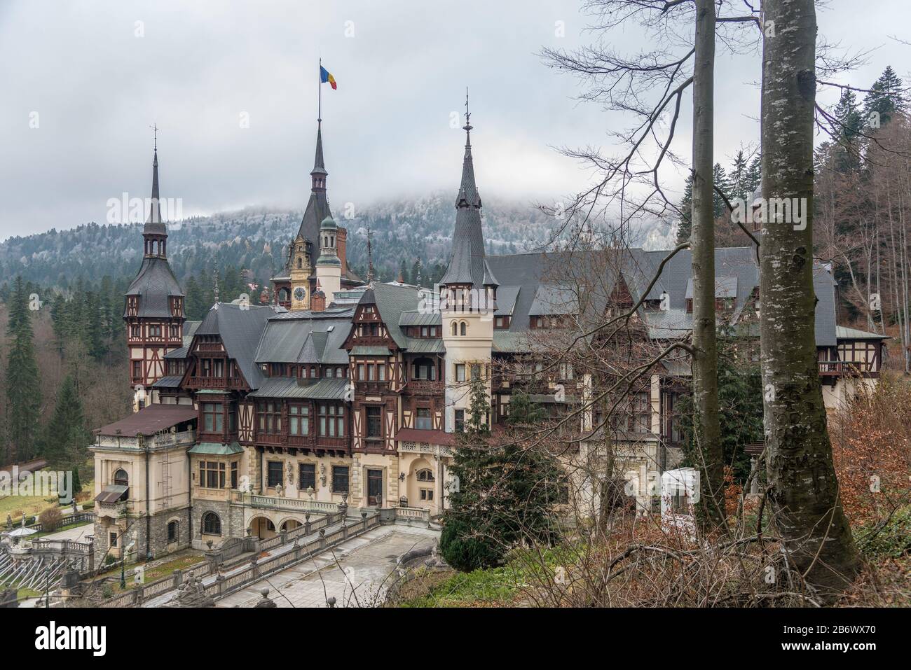 Neo-Renaissance Pelesh castle (Sinaia, Romania) against frosted forest ...