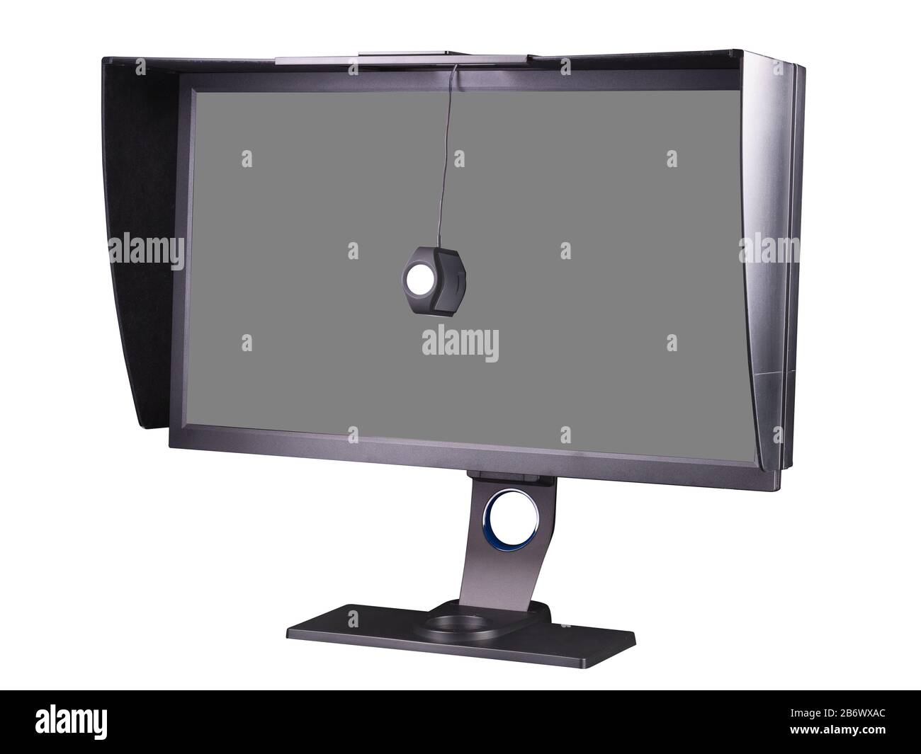 Professional monitor with shading hood and calibrator isolated on white ...