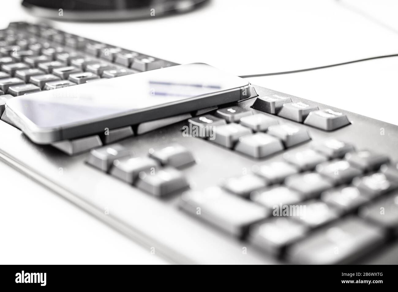 Smartphone On A Keyboard Stock Photo - Alamy