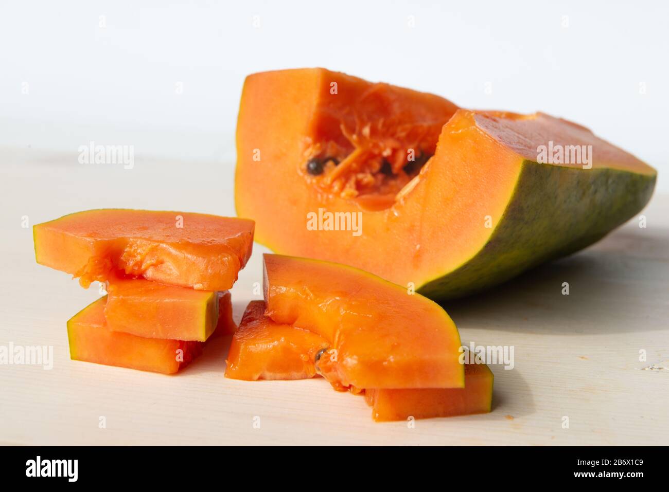 A sliced Papaya on a white cutting board Stock Photo - Alamy
