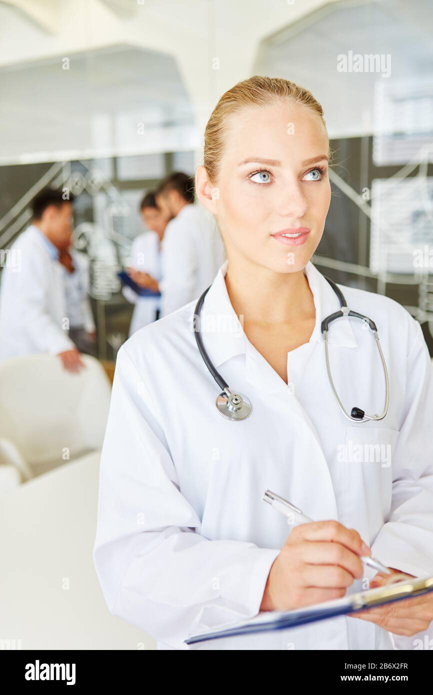 Blond woman as doctor with checklist on clipboard in hospital Stock ...