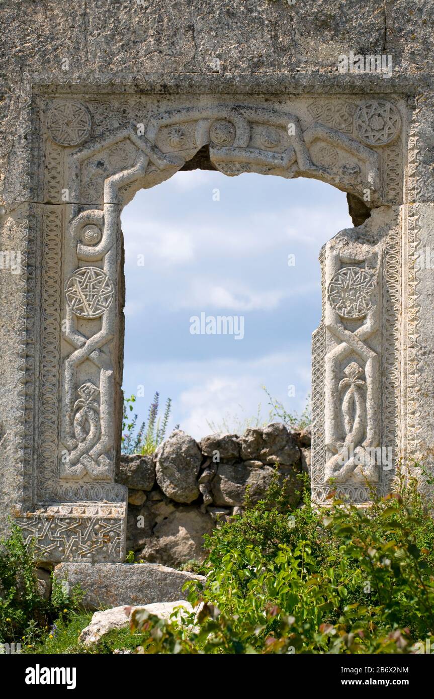 Mangup kale architecture (Crimea): old gate and bright green flora. The ...