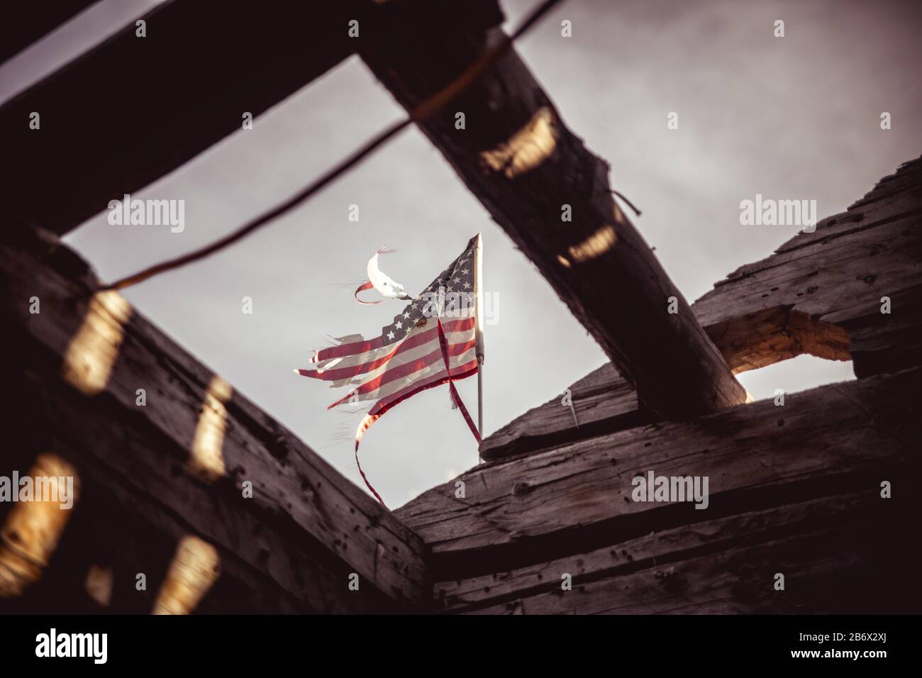 USA broken flag flowting in the sky with wood wall Stock Photo - Alamy