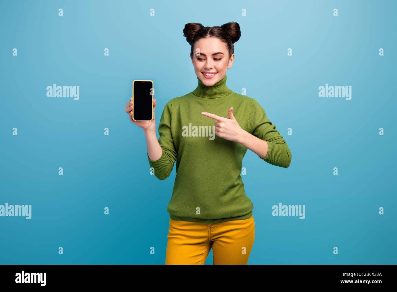 Photo of pretty lady sales manager hold new model smart phone show ...