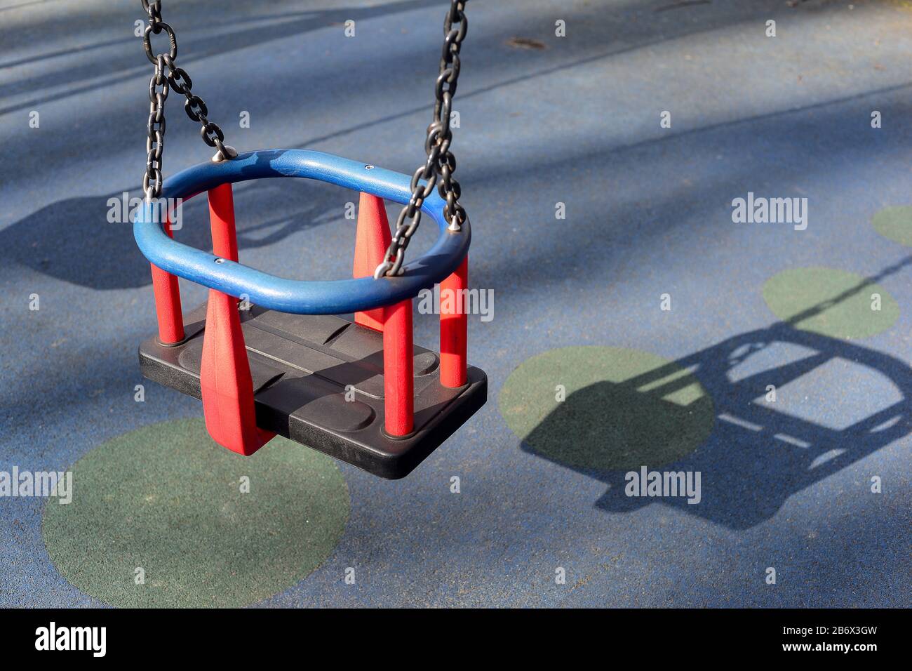 Empty designated playpark area for children, Empty swings casting ...