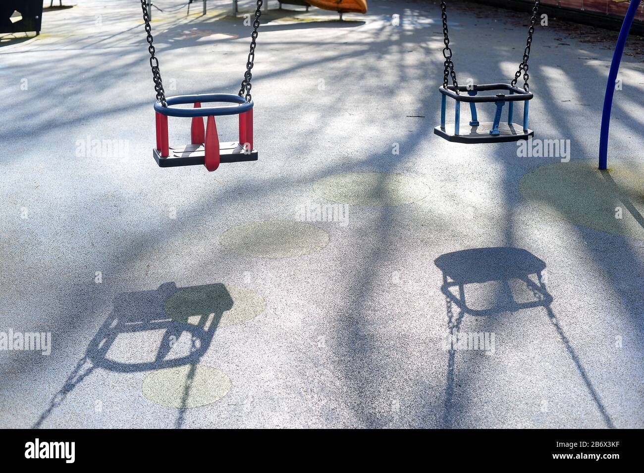 Empty designated playpark area for children, Empty swings casting ...