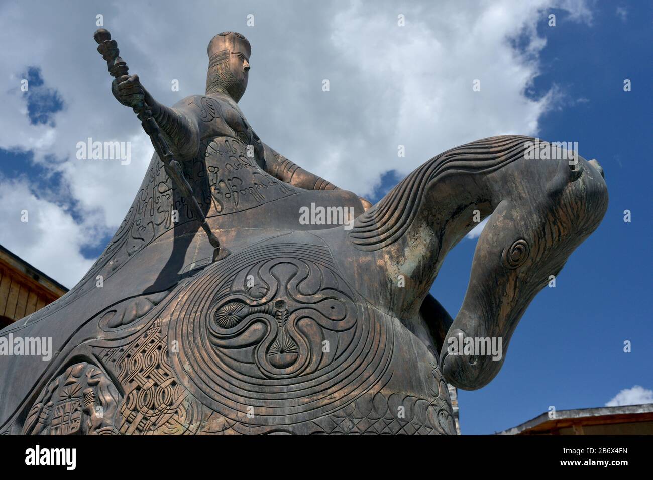 Modern monument of queen Tamar in Mestia (Svaneti) against blue sky ...