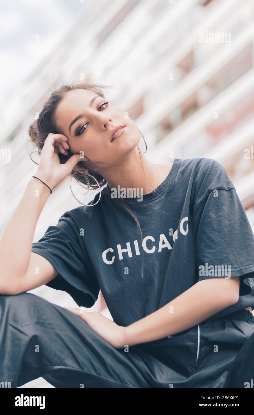 portrait of modern brunette girl on the street as a neighborhood ...