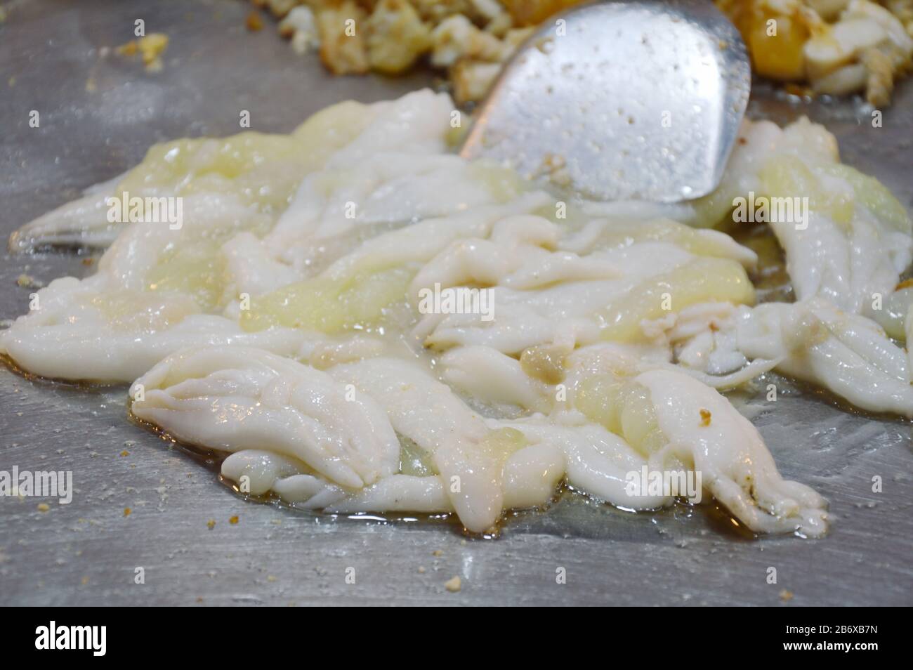 fried squid ovary or testis with oil on cooking pan Stock Photo - Alamy