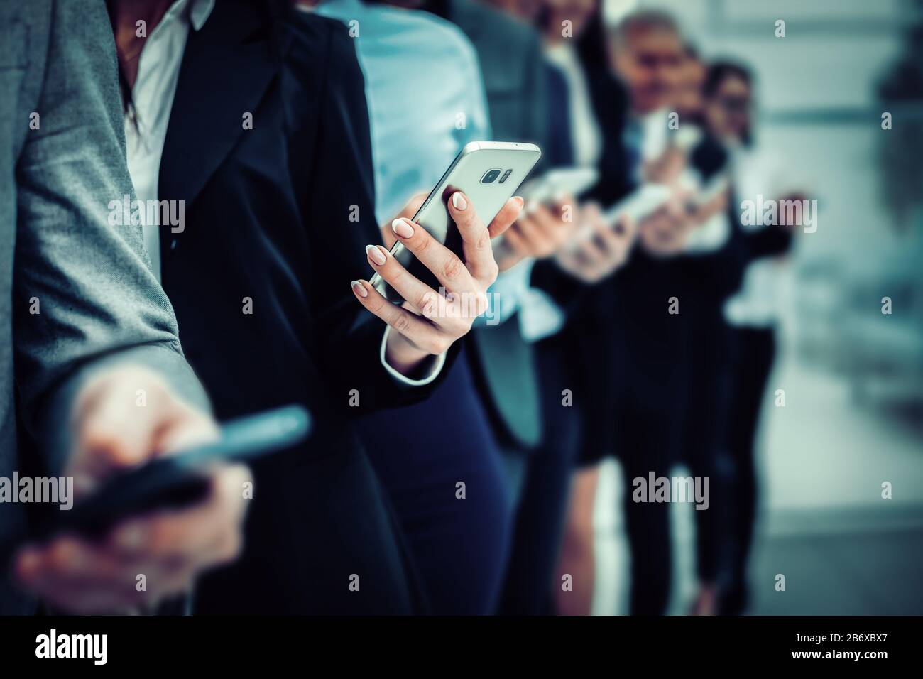 group of diverse employees with smartphones standing in a row Stock ...