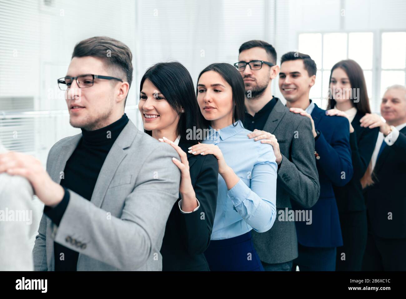 group of corporate employees standing behind each other Stock Photo - Alamy