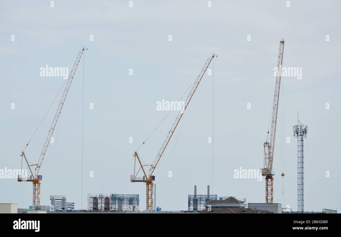heavy crane on roof top of under construction building Stock Photo - Alamy