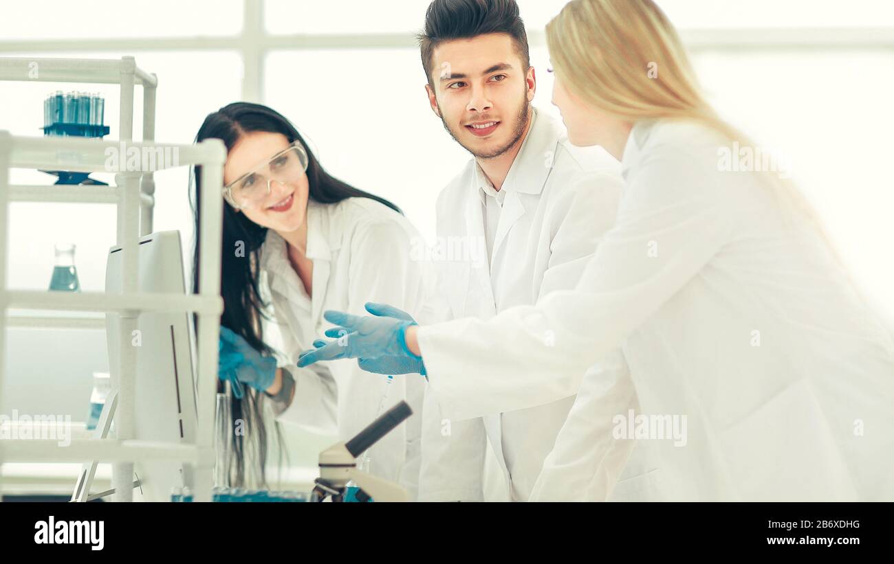 group of young scientist discussing something in their lab Stock Photo ...