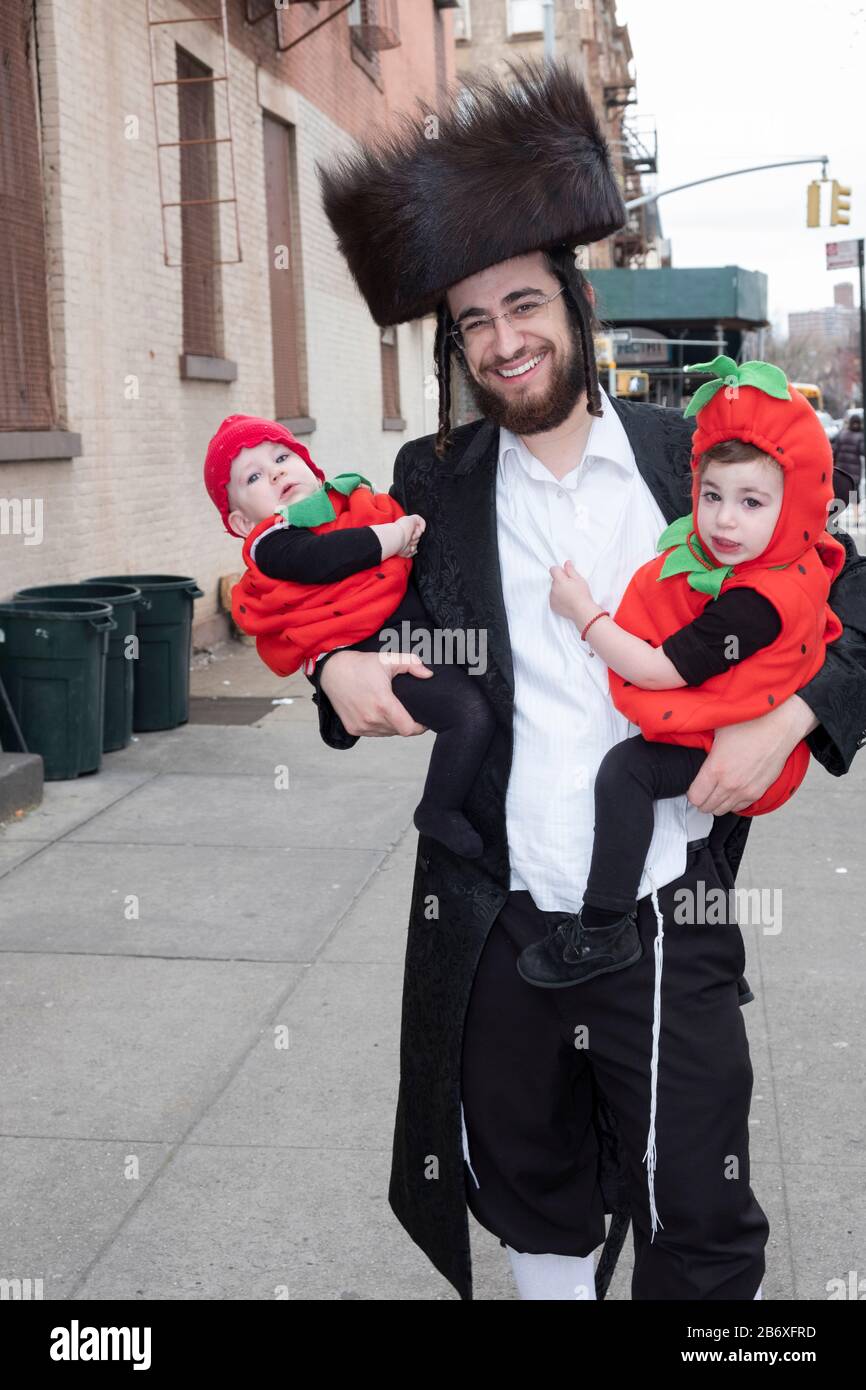 Portrait of an orthodox Jewish family on Purim. The children are ...