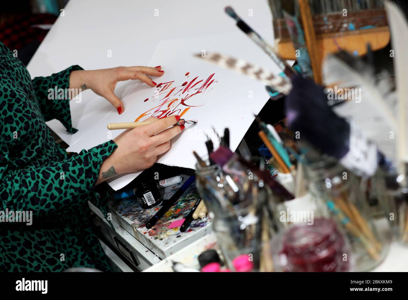 A calligraphy artist pictured working in Sussex, UK Stock Photo - Alamy