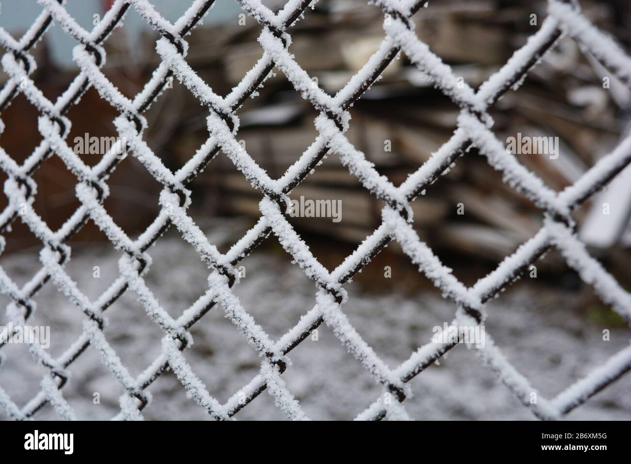Metallic old rusty netting net decorated with white snow, bright ...