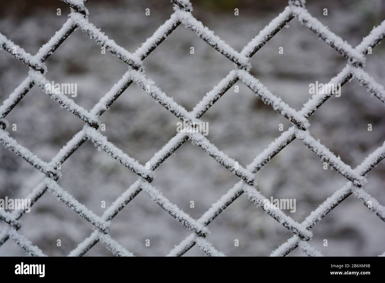 Metallic old rusty netting net decorated with white snow, bright ...