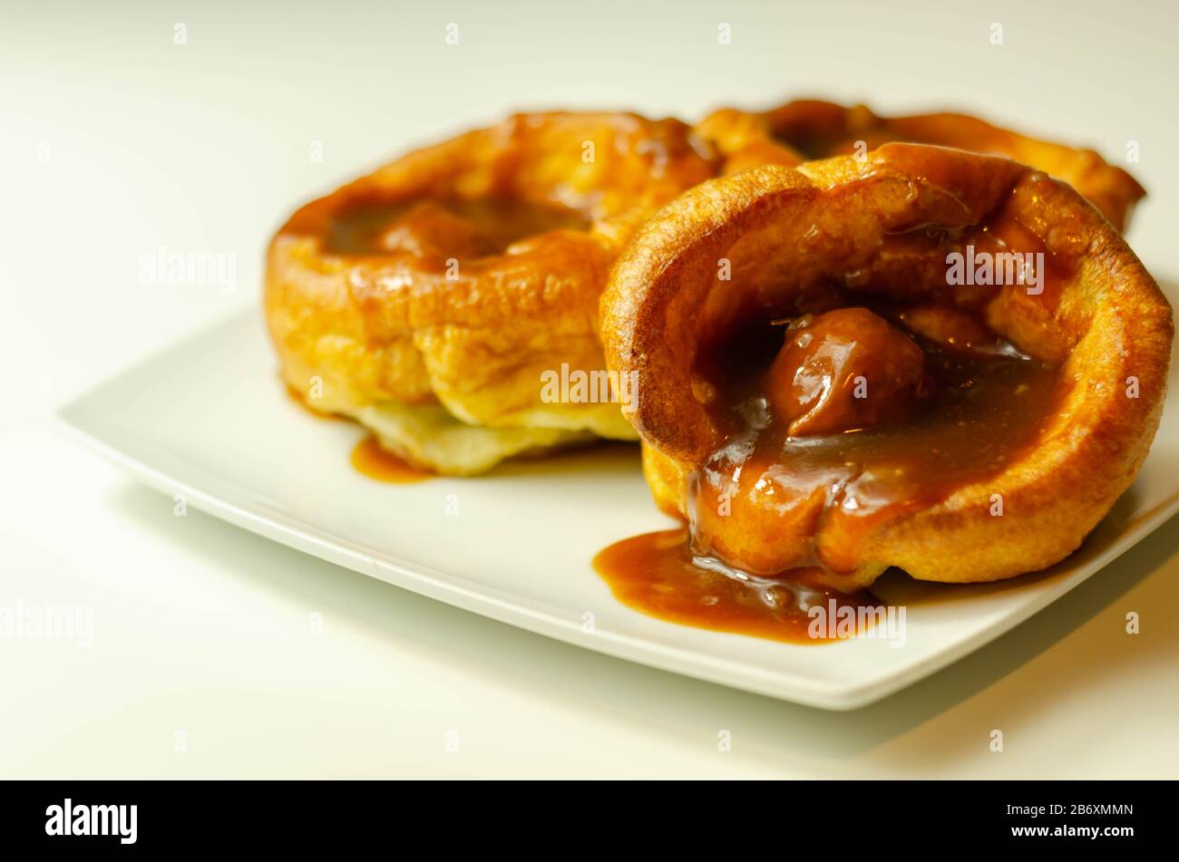 Traditional English Yorkshire pudding with meatballs and thick gravy ...
