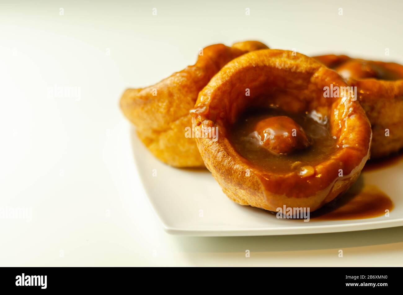 Traditional English Yorkshire pudding with meatballs and thick gravy ...